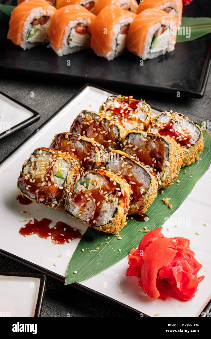 Tempura fried maki sushi rolls with sauce Stock Photo - Alamy