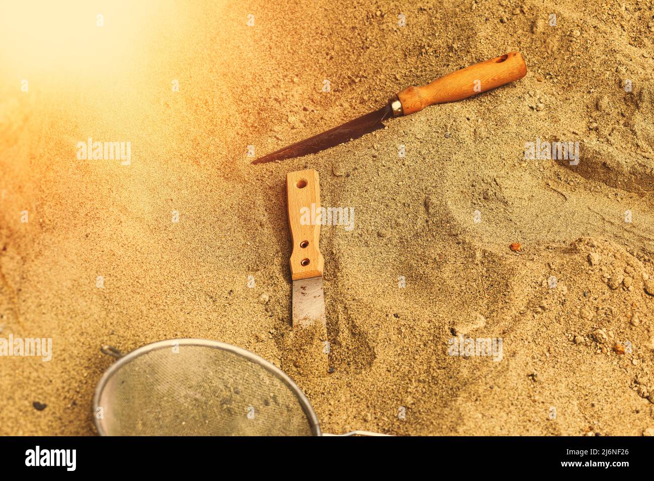 Shovel in the sand.Skeleton and archaeological tools.Digging for ...