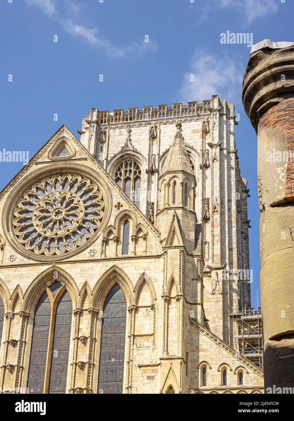 A tower of York Minster on a sunny day. The remains of a Roman column ...