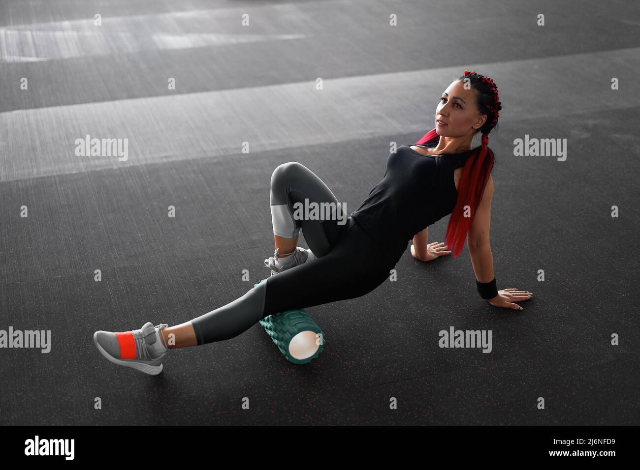 Woman massaging foam roll leg gym myofascial release exercise rolling ...