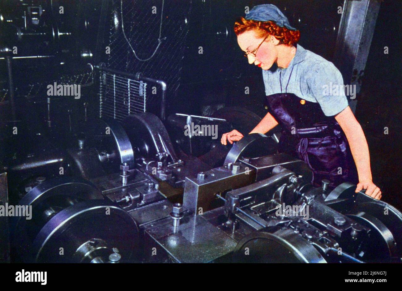 Female worker making small arms ammunition in a factory during the ...