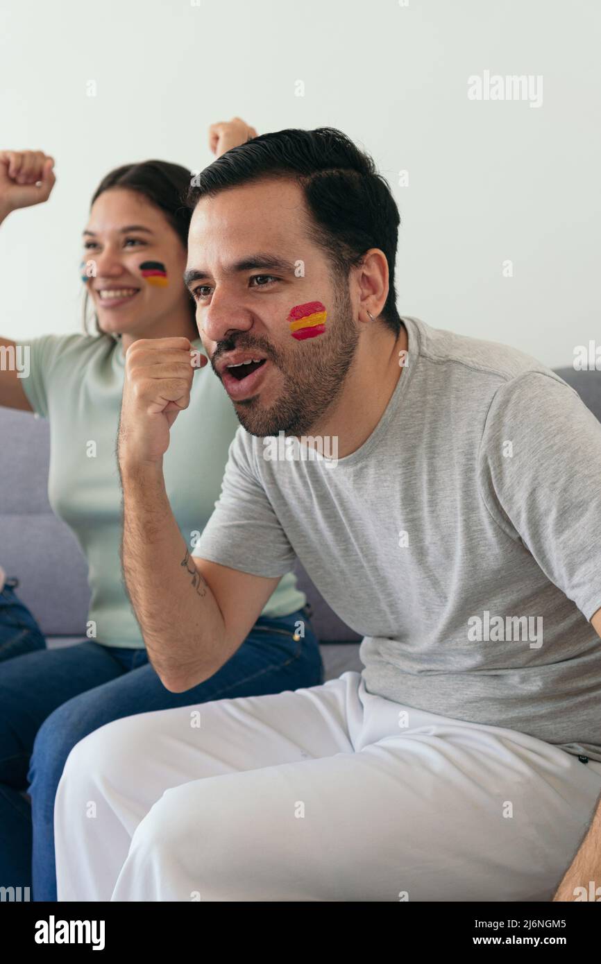 Spanish football woman fan wearing a flag cheering her soccer team ...