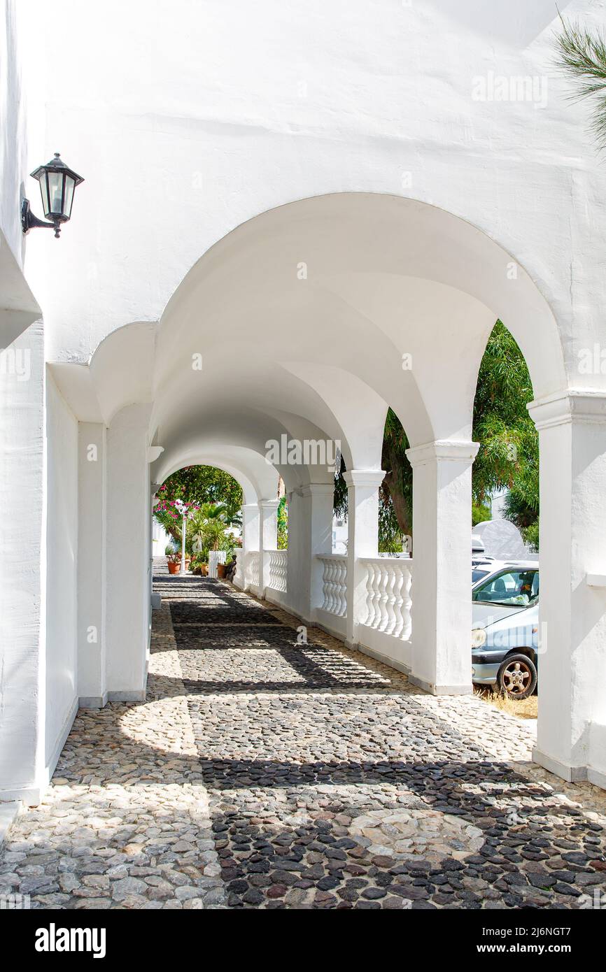 Greek architecture on vacation. Arched corridor with columns in a ...