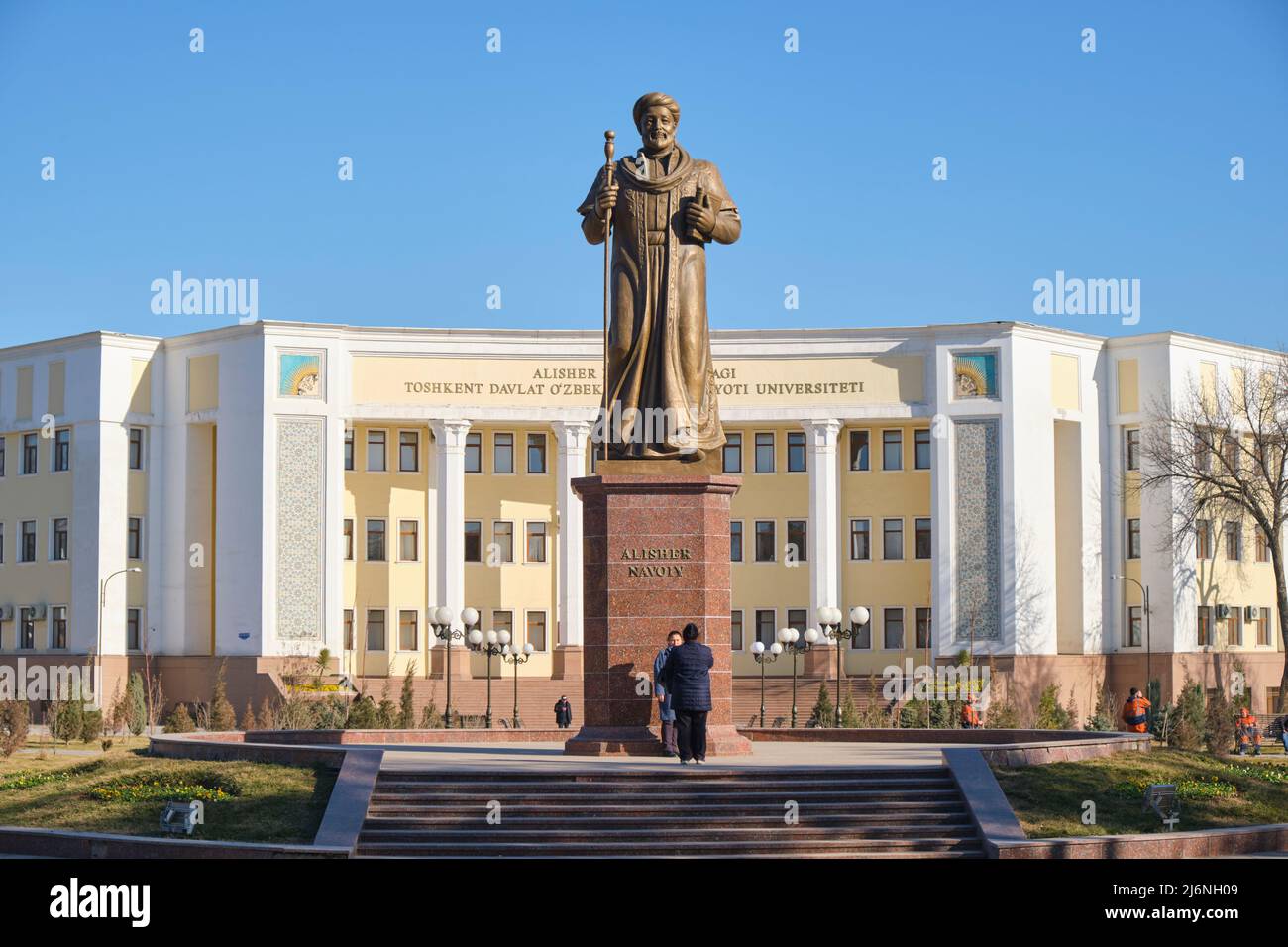 A statue of the poet Alisher Navoi in front of the facade, entrance of ...