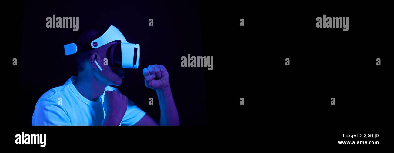 Man with virtual reality headset is playing game and fighting. Concept ...
