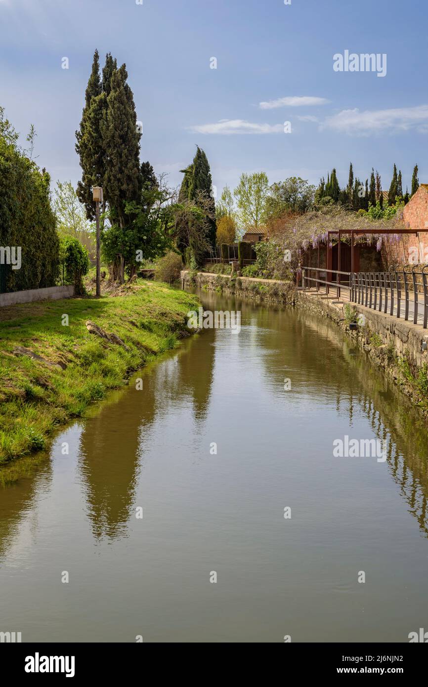 Rec del Molí irrigation channel and remains of the old medieval wall of ...