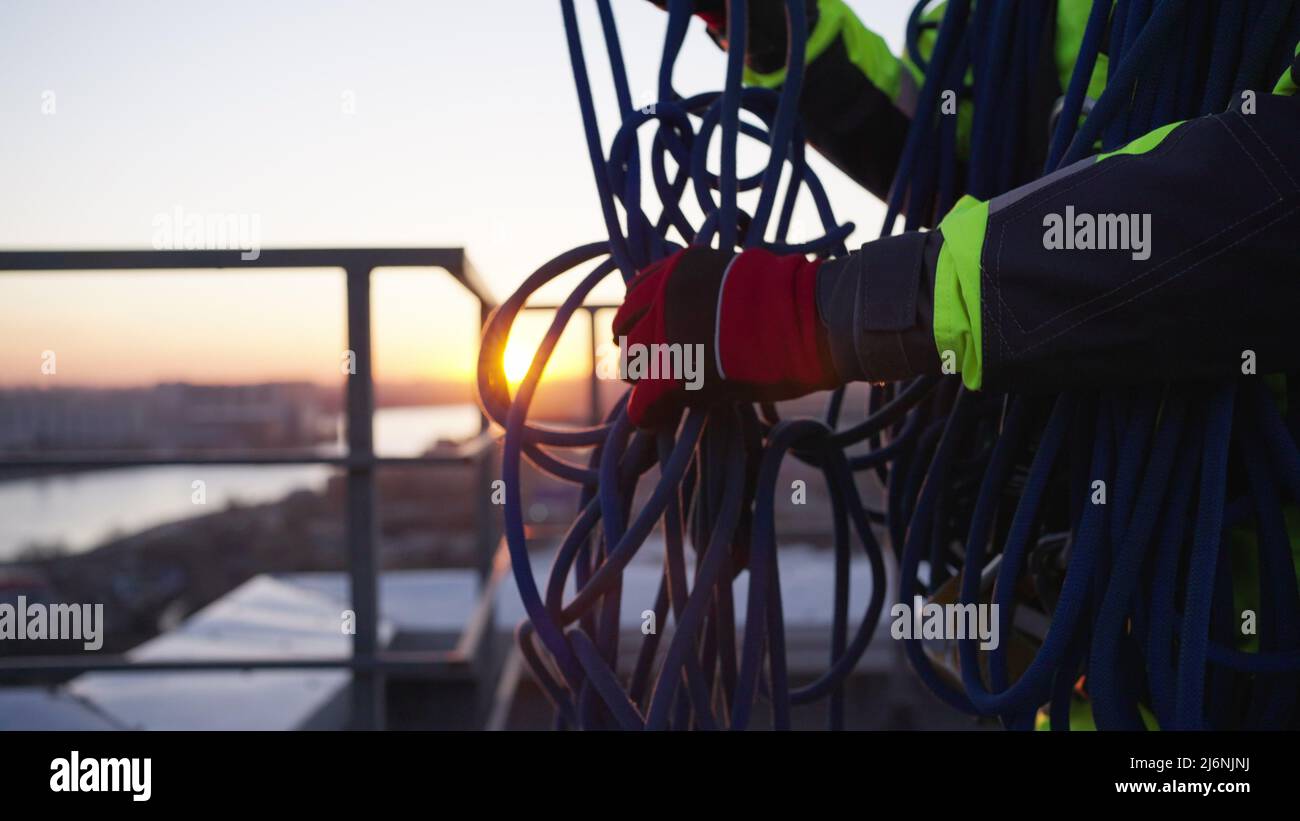 Skein of rope in hands of professional climber in special equipment ...