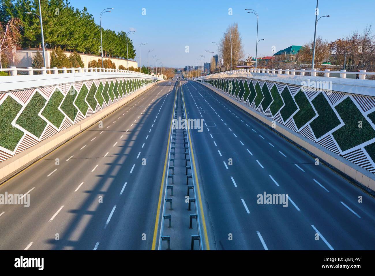 A view down from an overpass at the modern, multilane main avenue ...