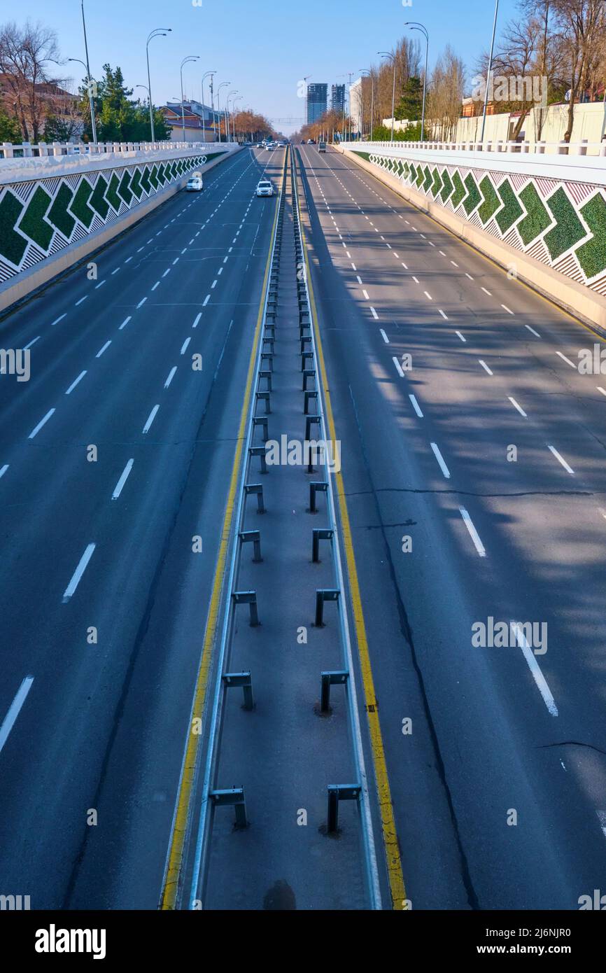A view down from an overpass at the modern, multilane main avenue ...