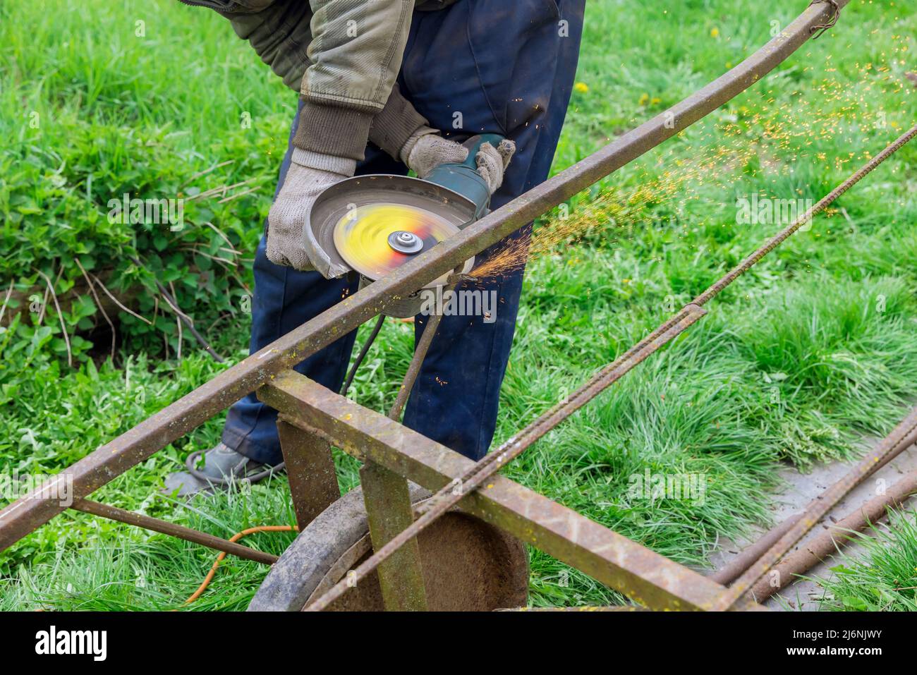Industrial working on cutting a metal steel with hands saw with sharp ...