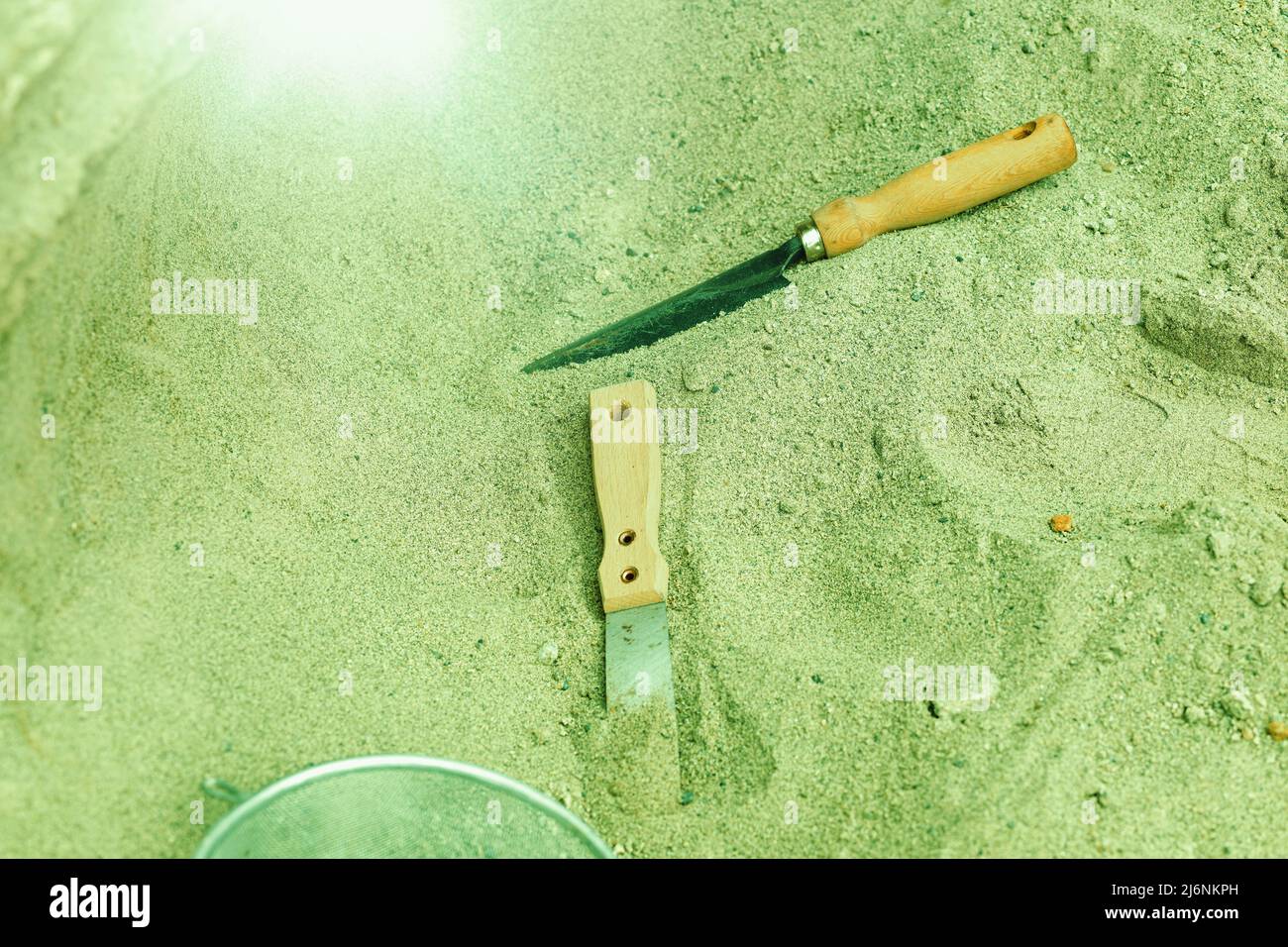 Shovel in the sand.Skeleton and archaeological tools.Digging for ...
