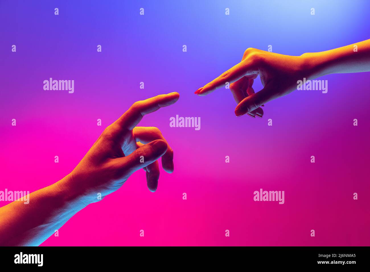 Two human hands trying to touch each other isolated on gradient blue ...