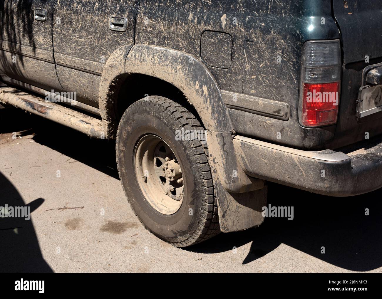 Photo of machine covered in mud. Wheels and body of car splattered with ...