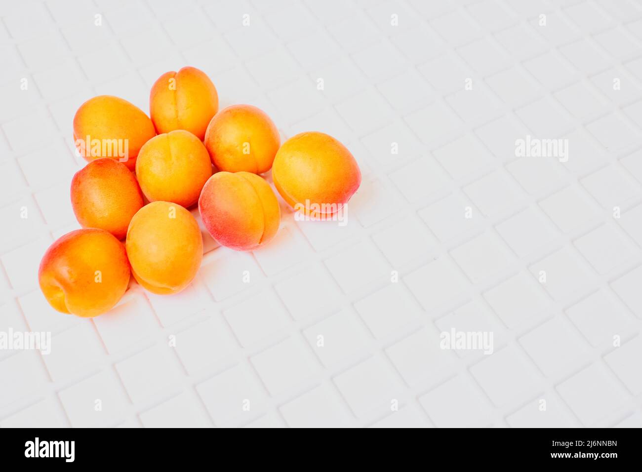 Fresh ripe apricot fruits isolated on white ribbed background Stock ...