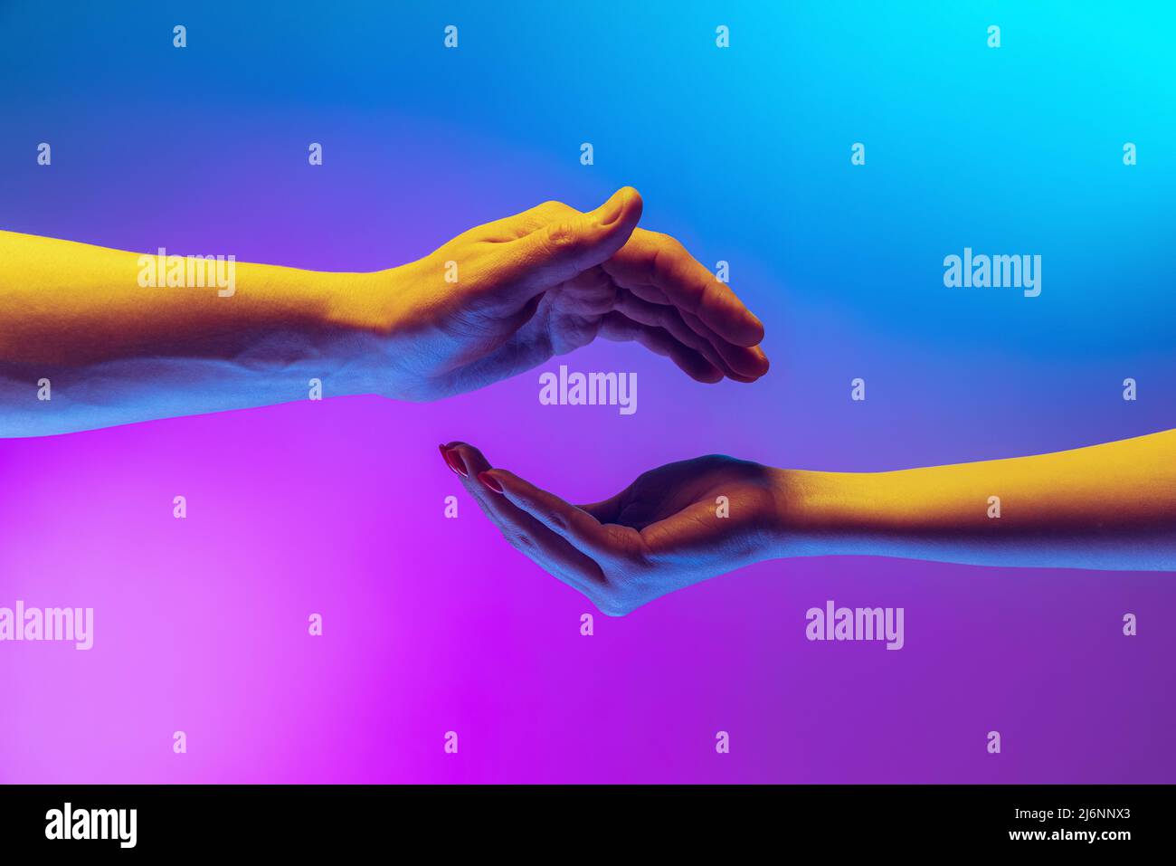 Two authentic hands trying to touch each other isolated on gradient ...