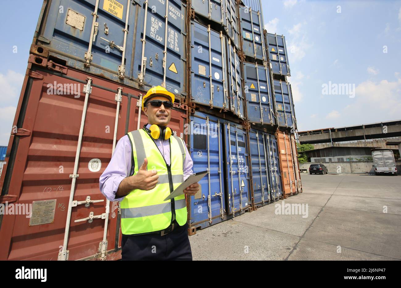 Foreman control Industrial Container Cargo freight ship at industry ...