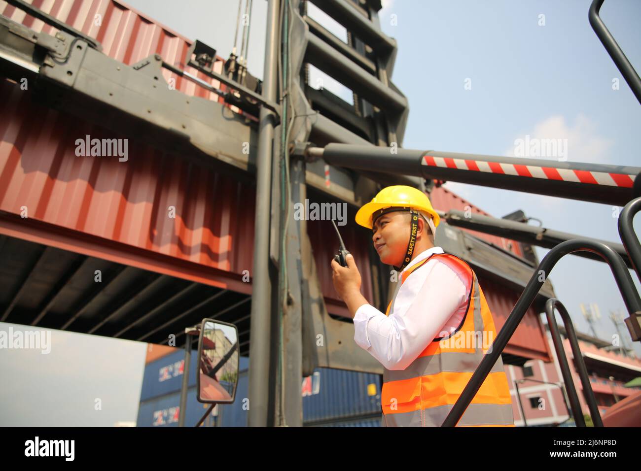 Foreman control Industrial Container Cargo freight ship at industry ...