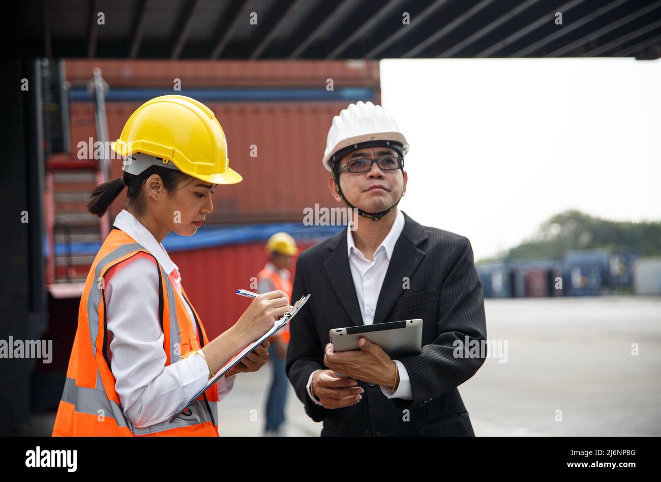 Foreman control Industrial Container Cargo freight ship at industry ...