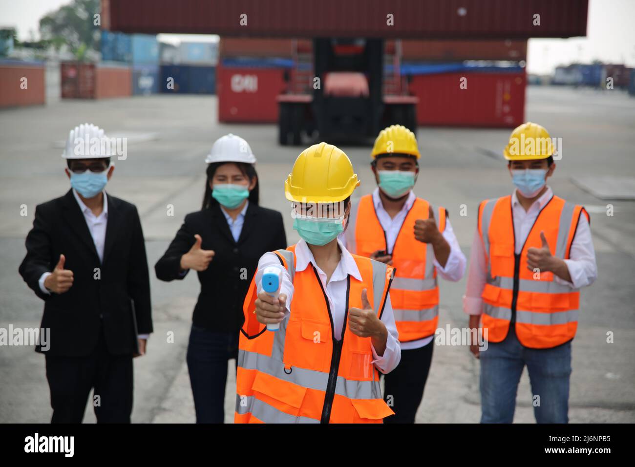 Factory workers with face masks protected against corona virus doing ...