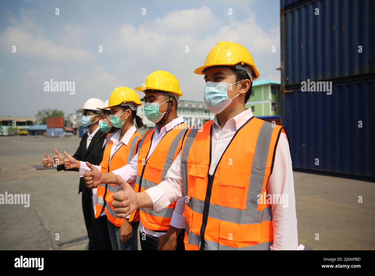 Factory workers with face masks protected against corona virus doing ...