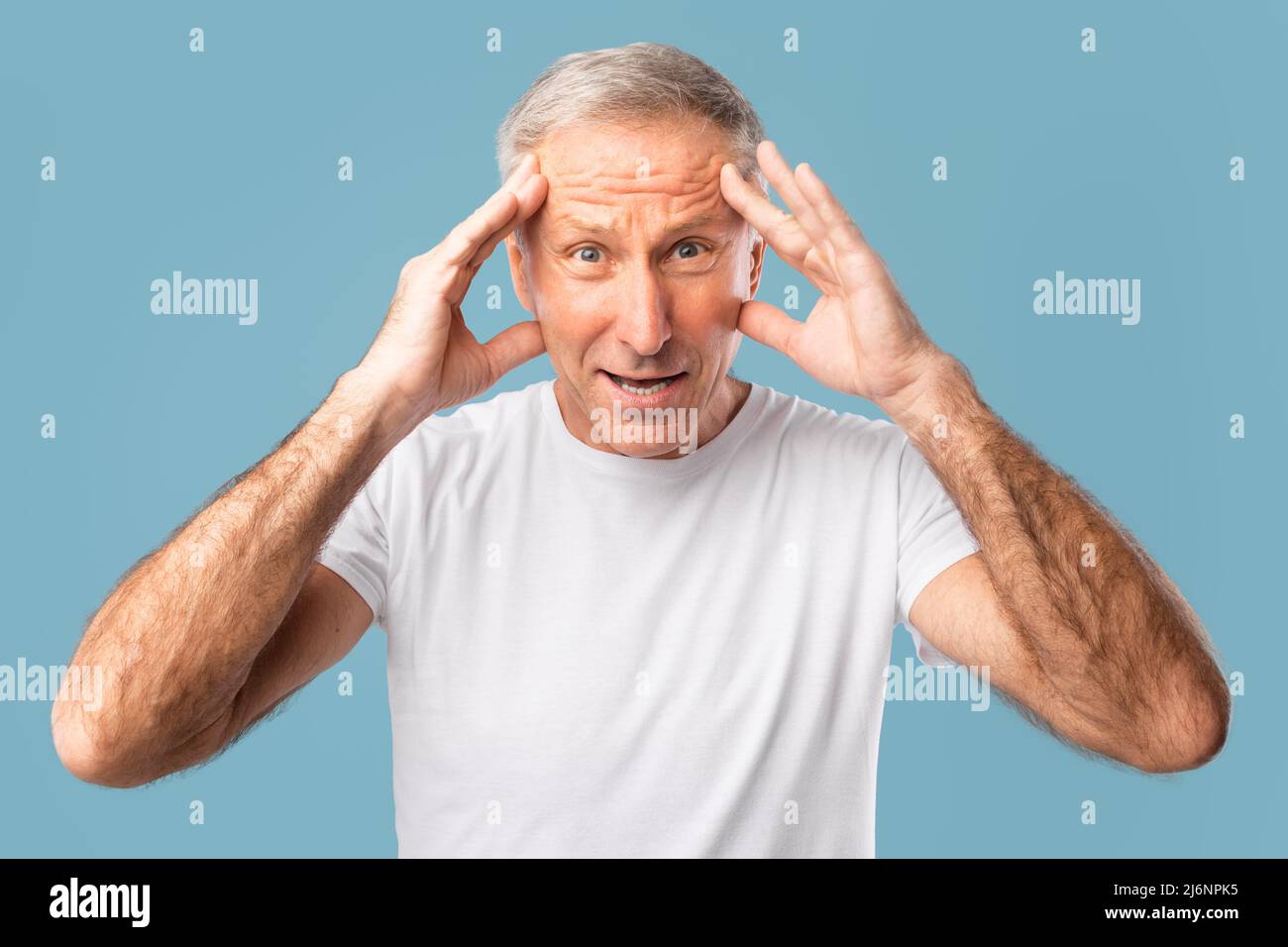 Shocked mature man staring at camera at studio Stock Photo - Alamy