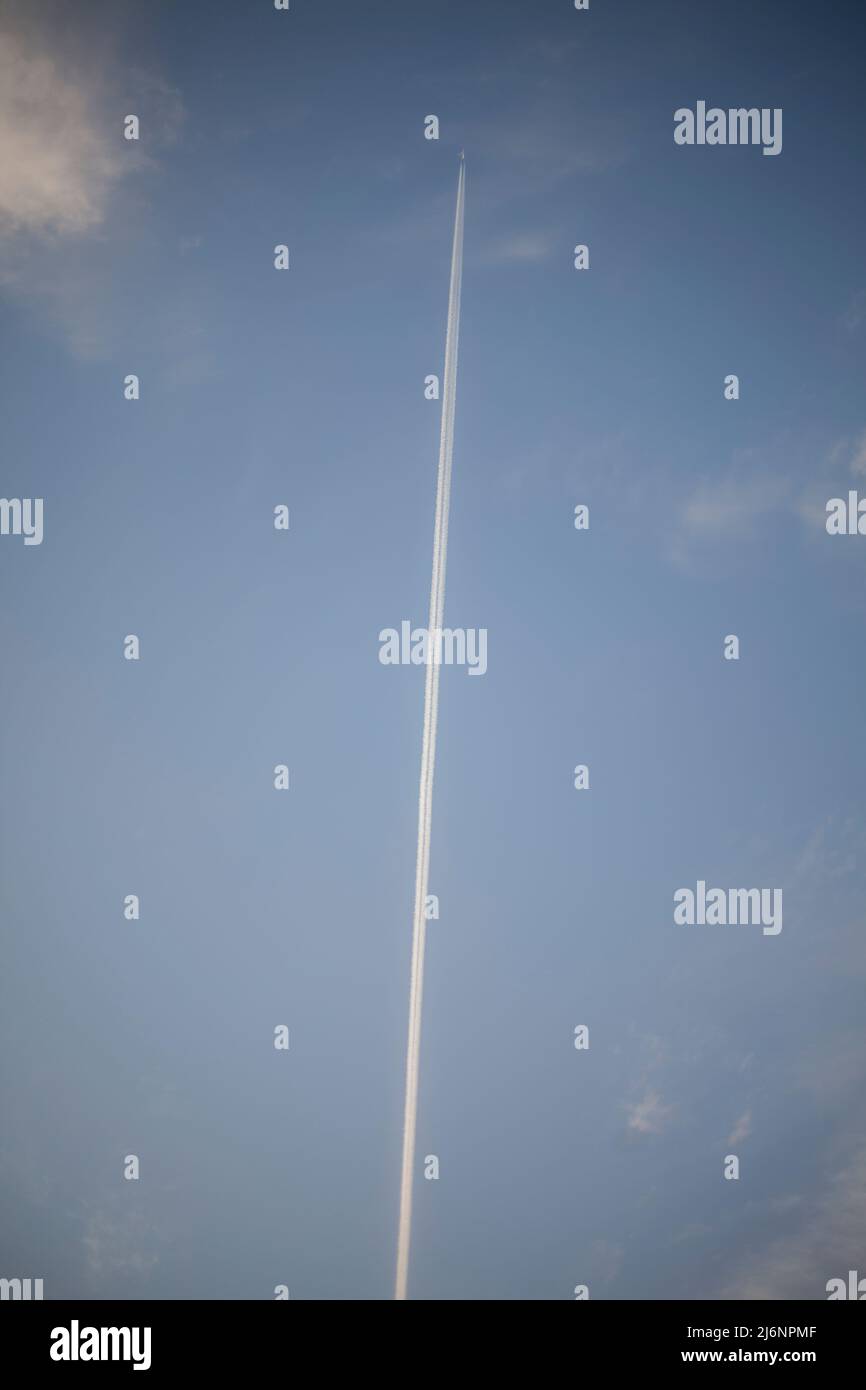Trace of plane in sky. White line in blue sky. Vertical frame of oxygen ...