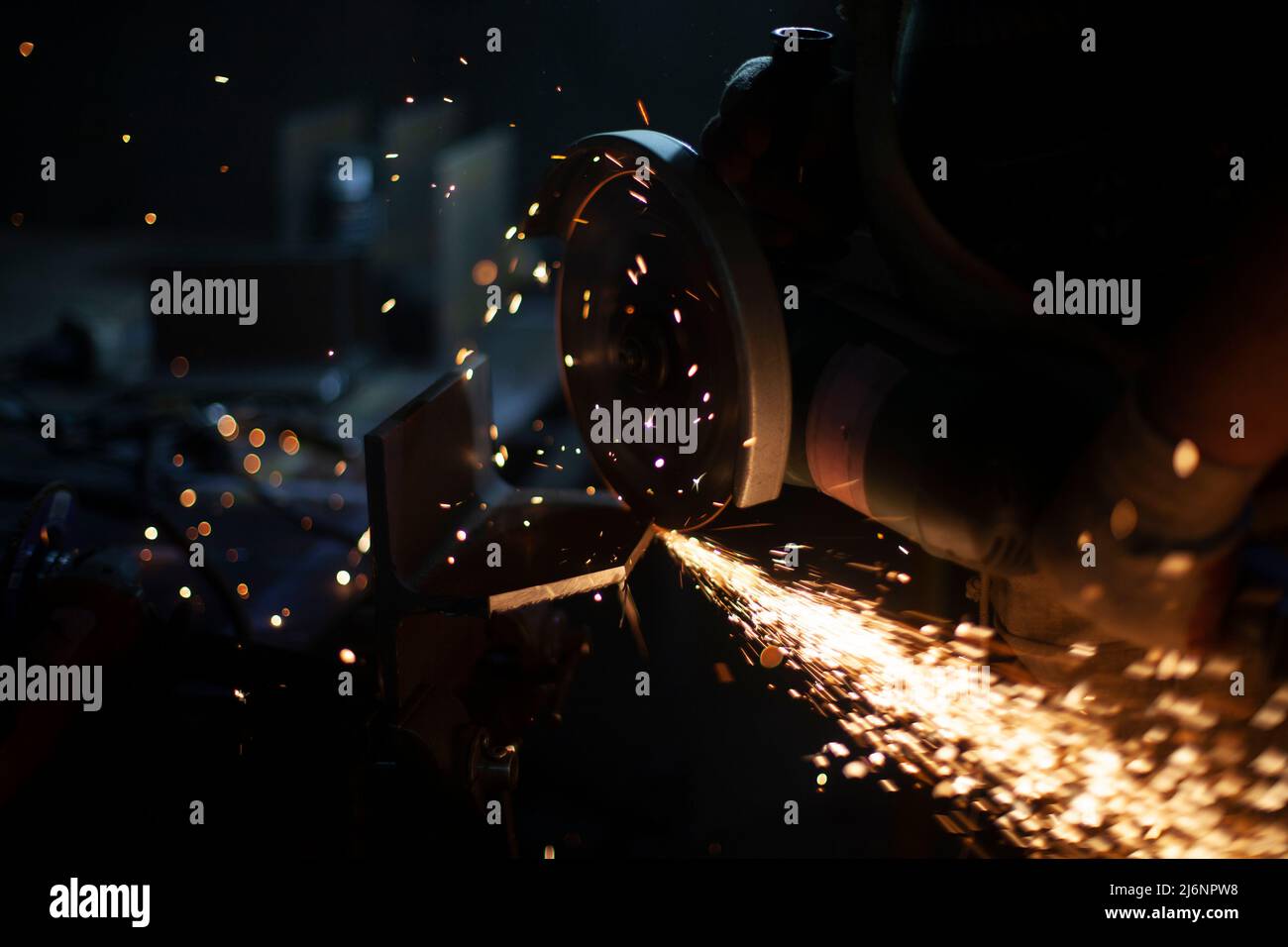 Work as grinder in workshop. Metal grinding. Sparks from high ...
