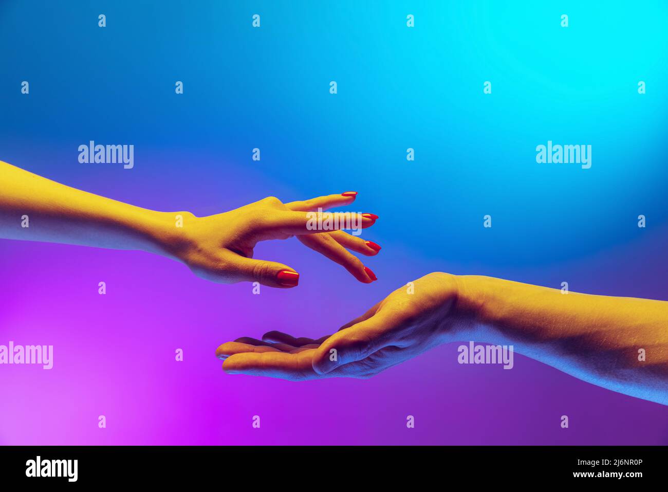 Two authentic hands trying to touch each other isolated on gradient ...