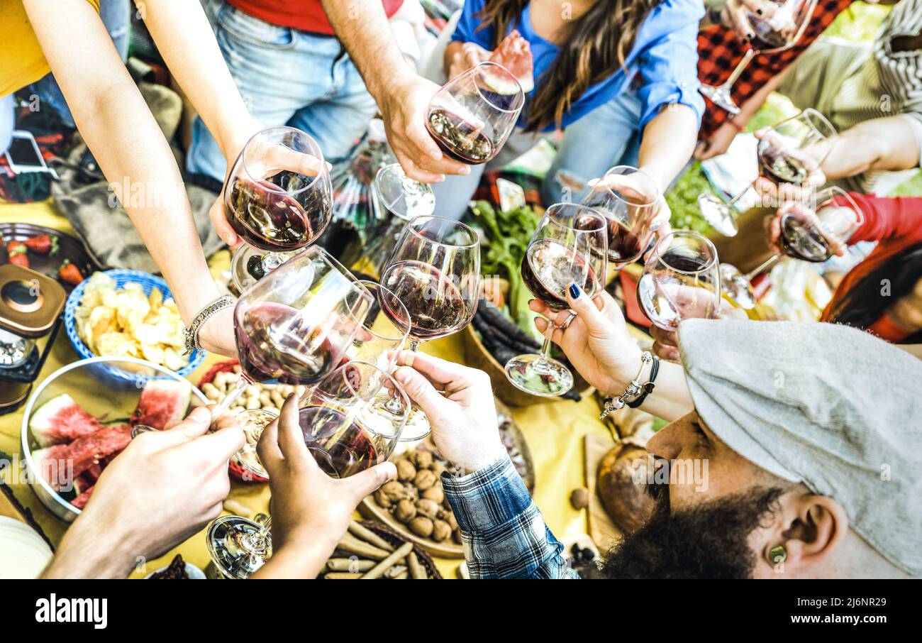 Top View Of Friend Hands Toasting Red Wine Glass And Having Fun Outdoor