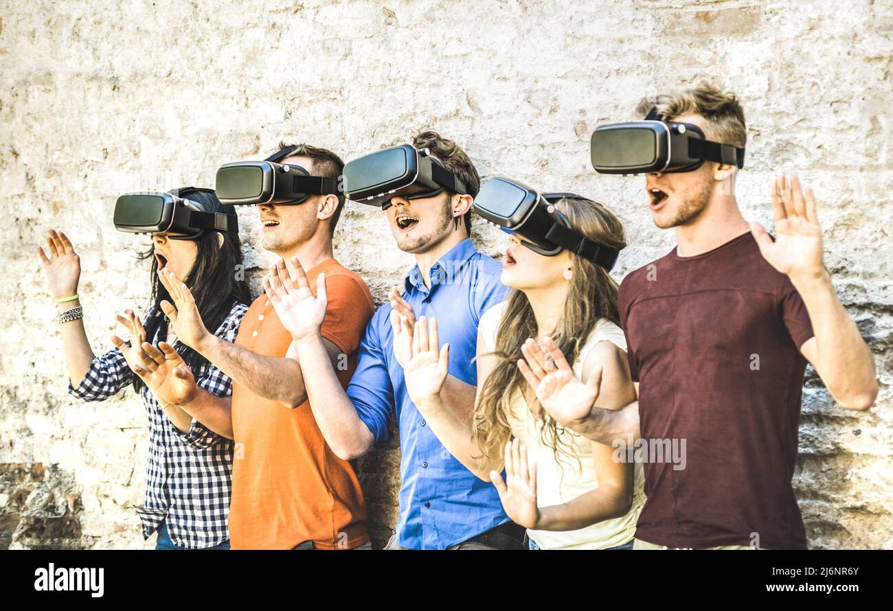 Friends group playing on vr glasses outdoors - Virtual reality and ...