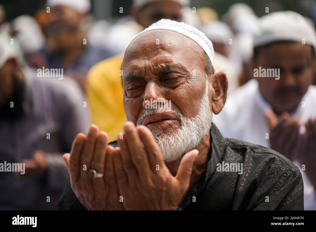 Muslim man crying during offer prayer at a Eidgah to start the Eid al ...