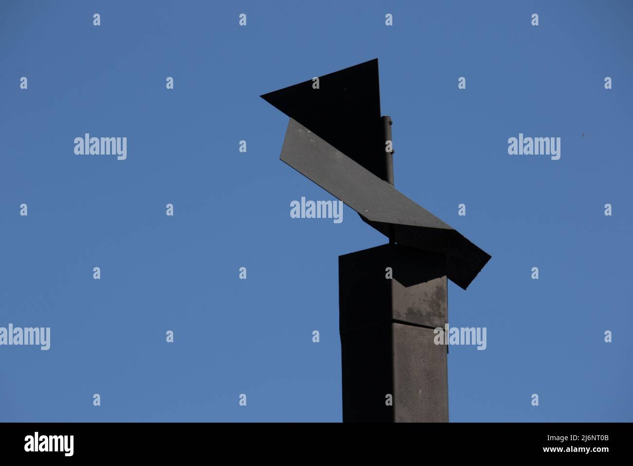A black smokeless metal chimney isolated against a clear blue sky Stock ...