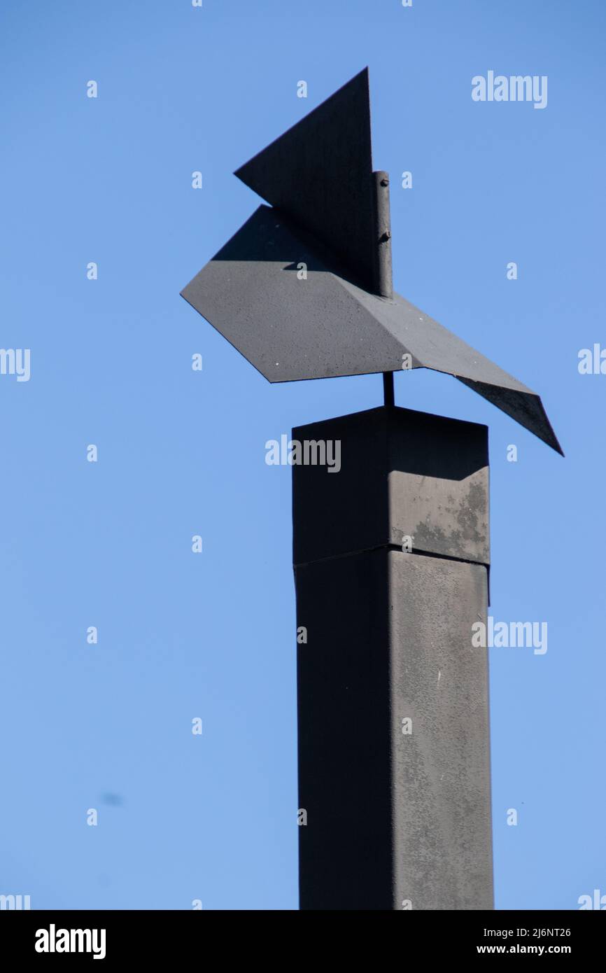 A black smokeless metal chimney isolated against a clear blue sky Stock ...