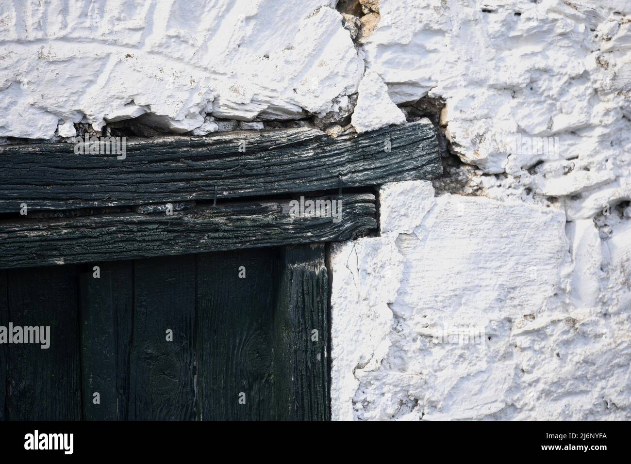 Old traditional rural house antique wooden lintel on a whitewashed ...