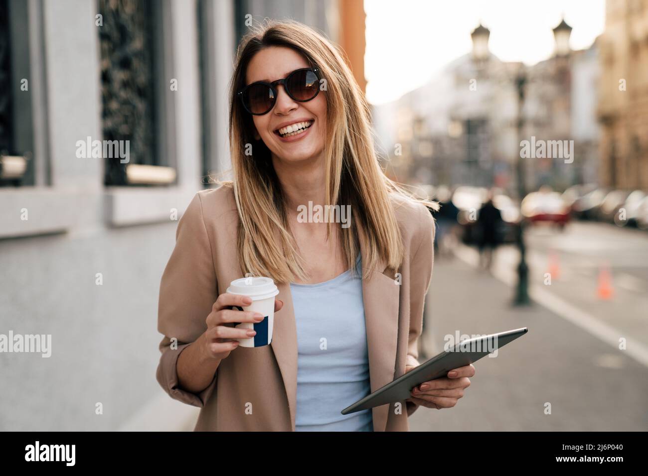 Portrait of a successful woman using digital tablet during quick break ...