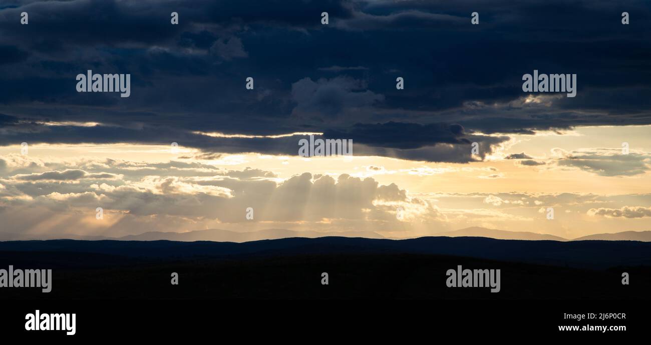 amazing sunset sky over green hills in early summer Stock Photo - Alamy