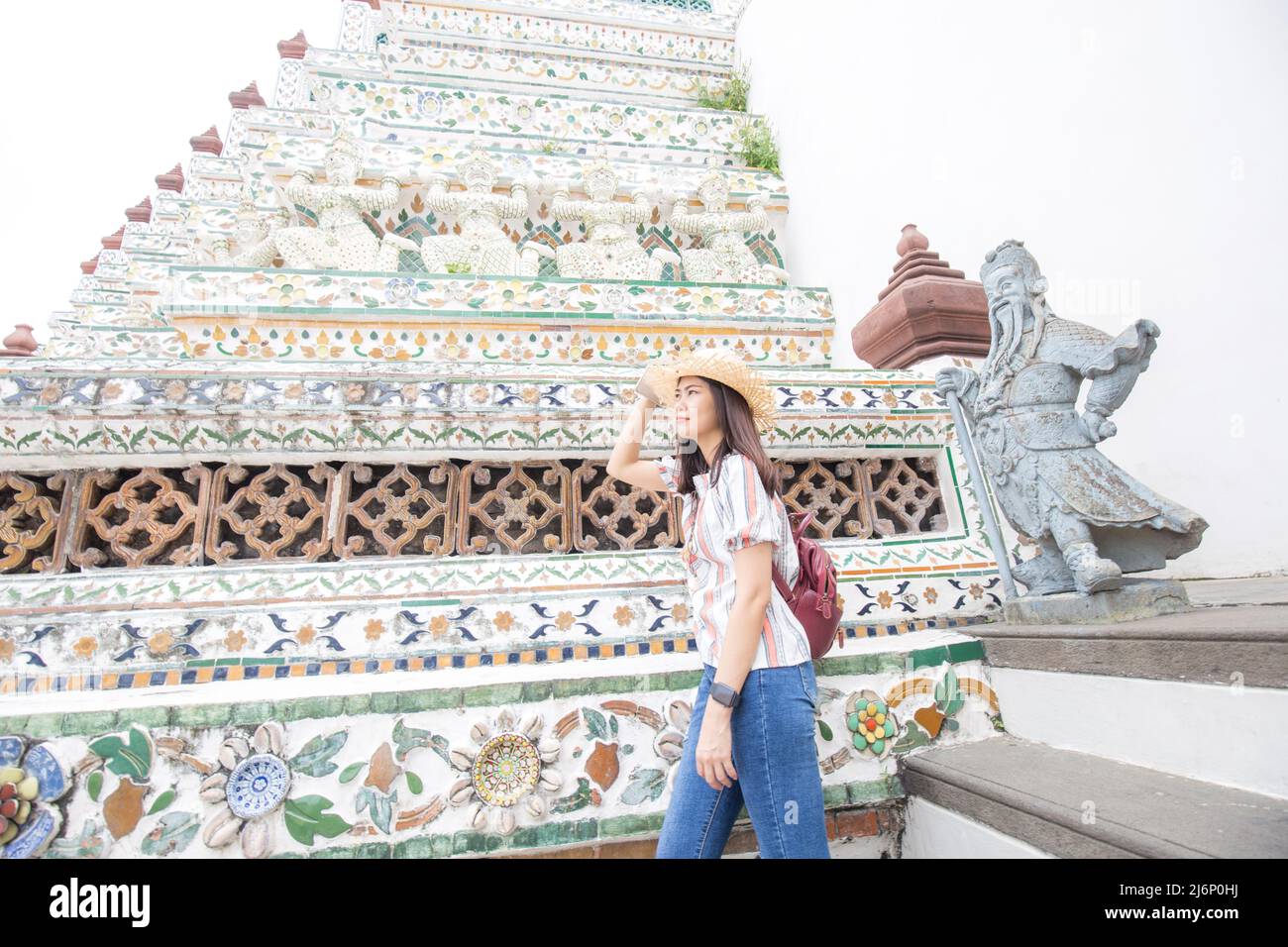 Asian girl tourist smiling while visiting Wat Arun or Temple of Dawn ...