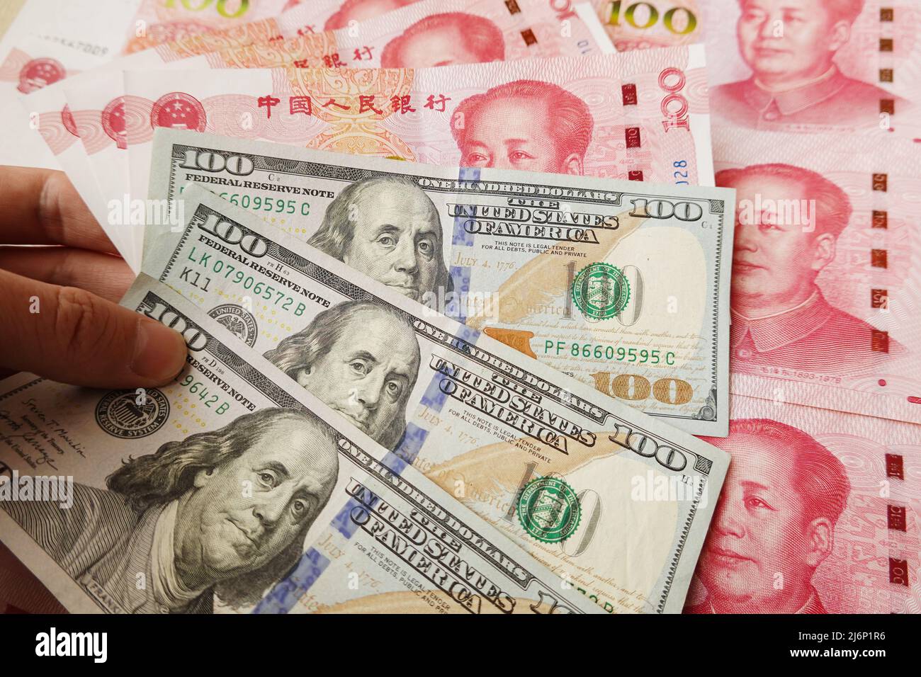 In this photo illustration, 100 US dollar notes and 100 RMB notes seen ...