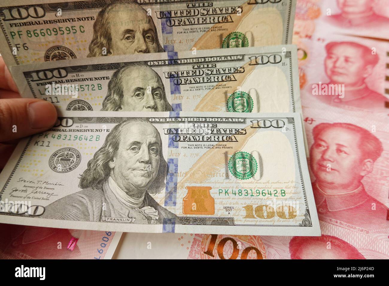 In this photo illustration, 100 US dollar notes and 100 RMB notes seen ...
