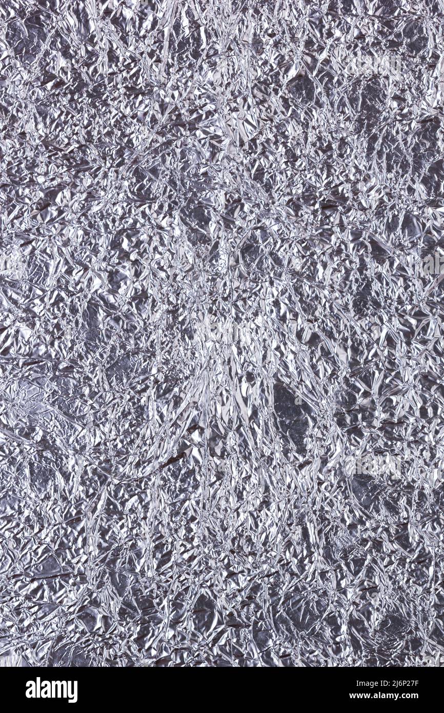 Shiny heavily wrinkled metal silver gray foil vertical texture ...