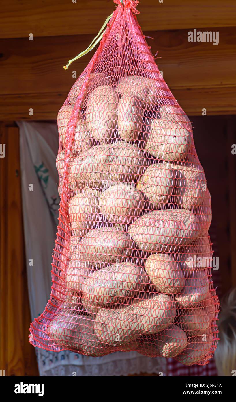 Hanging sack of potatoes Stock Photo - Alamy
