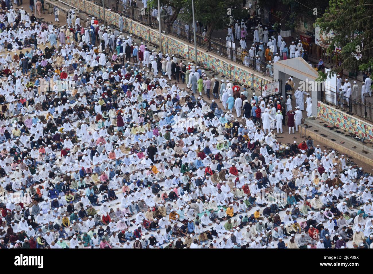 Muslim Devotees entering a ground to offer Eid-al-Fitr Prayers to mark ...