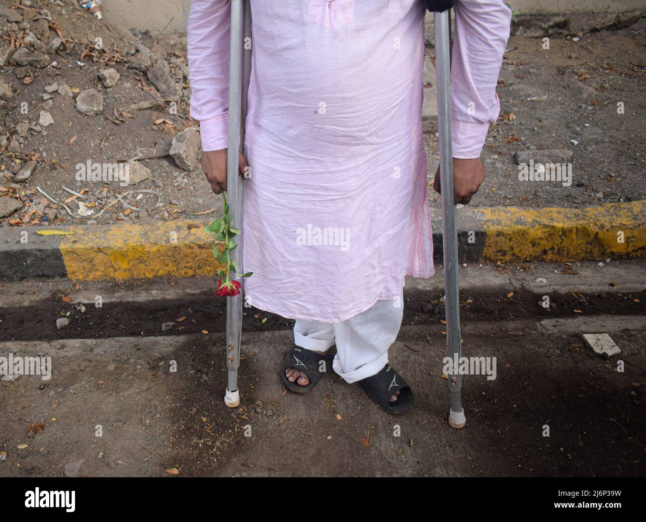 A Muslim Devotee stands with a rose in his hand on the occasion of Eid ...
