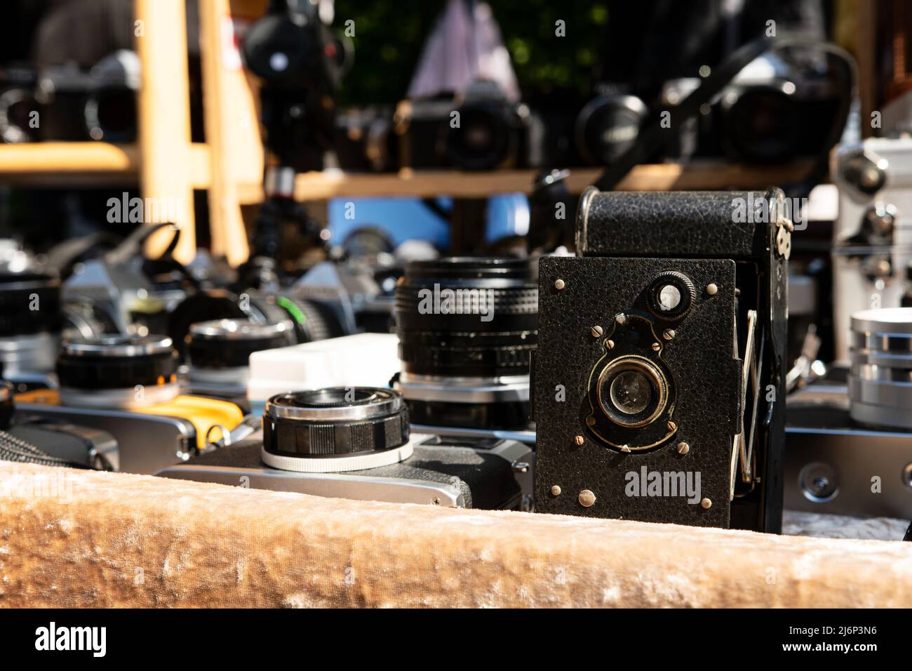 Antique and old camera in focus. In the background are different old ...