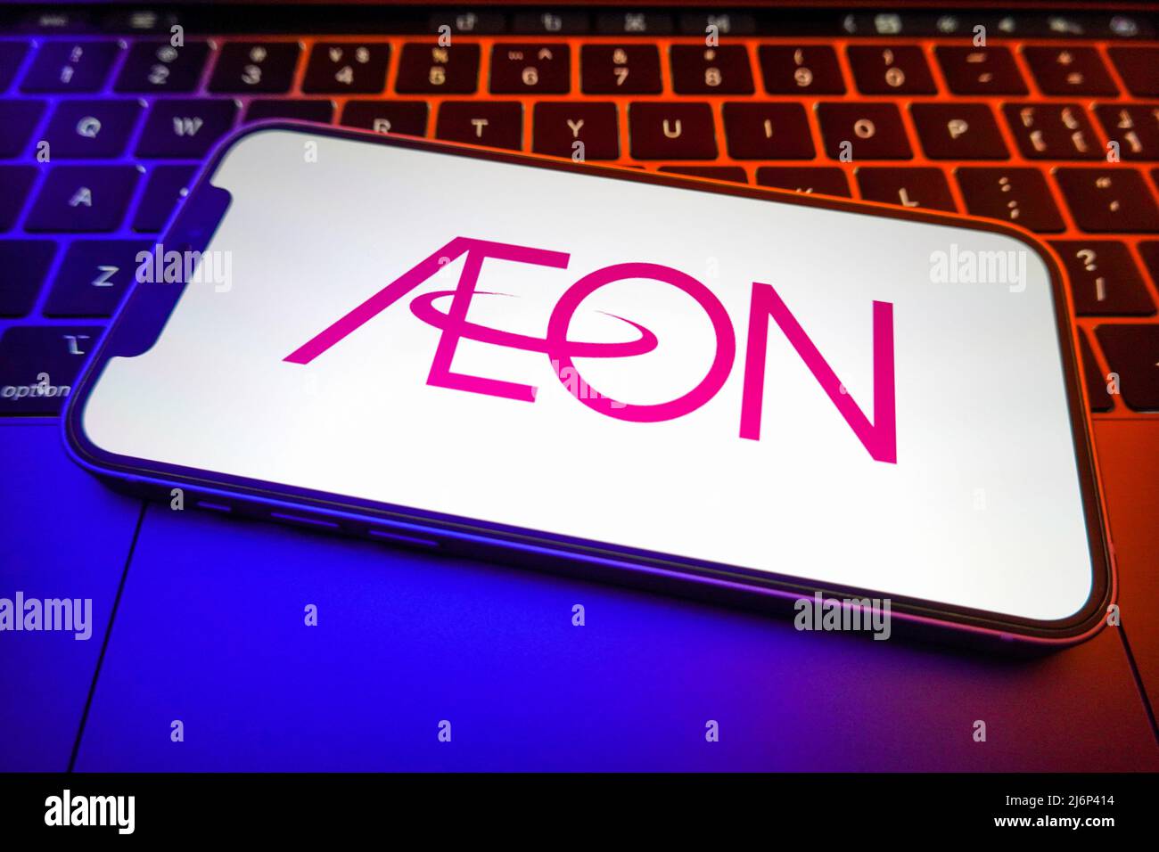 In this photo illustration, an AEON logo is displayed on the screen of ...