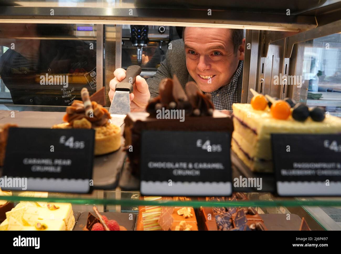 Scottish Conservative leader Douglas Ross looks as some cakes during ...