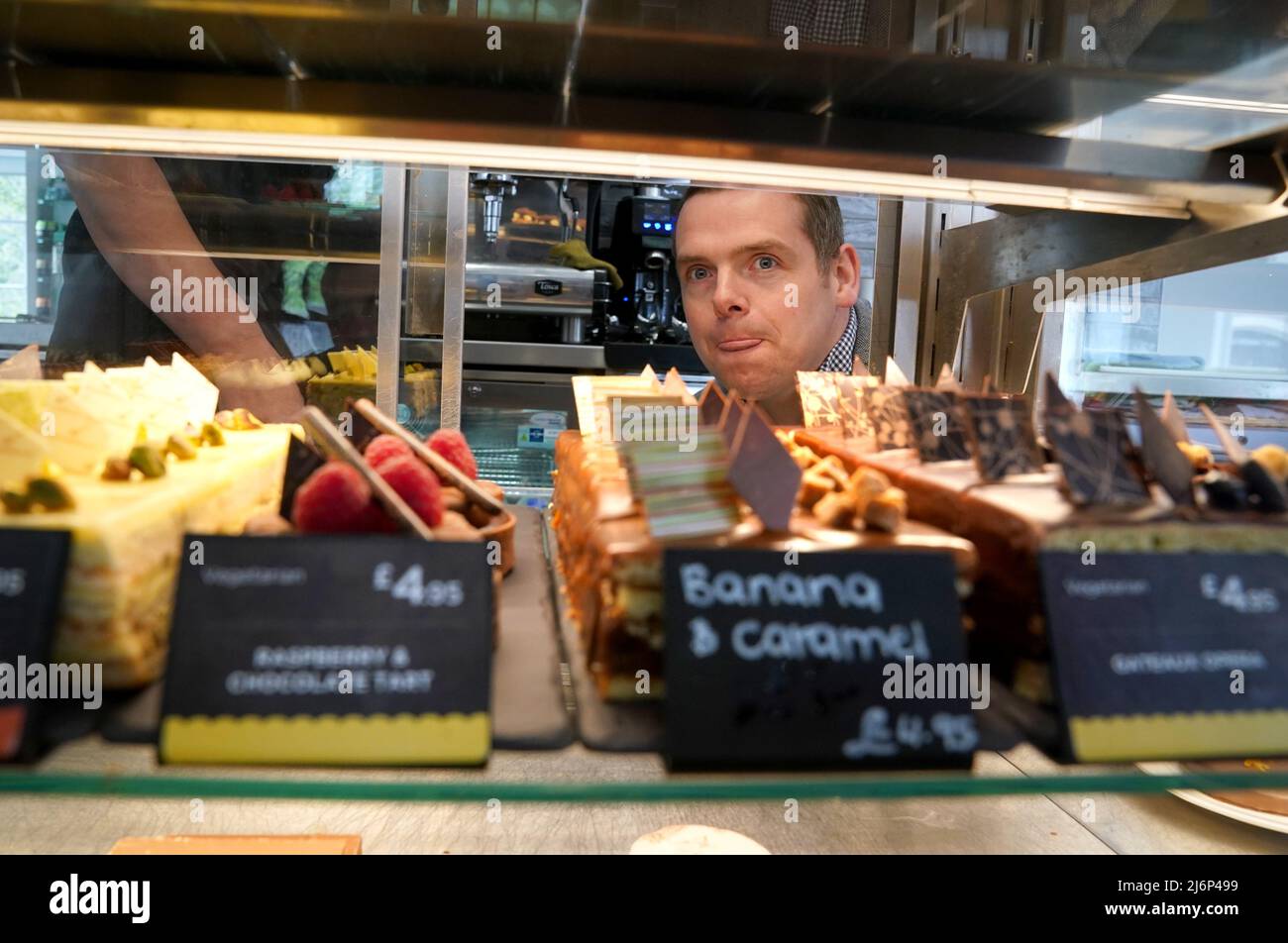 Scottish Conservative leader Douglas Ross looks as some cakes during ...
