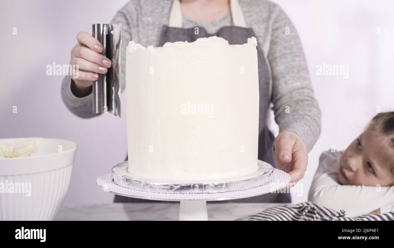 Step by step. Frosting round funfetti cake with white italian ...