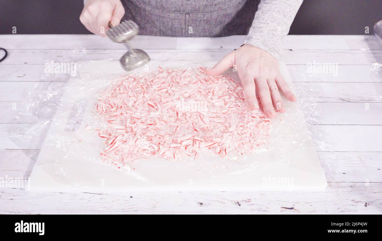 Step by step. Breaking candy cane candies into small pieces Stock Photo ...