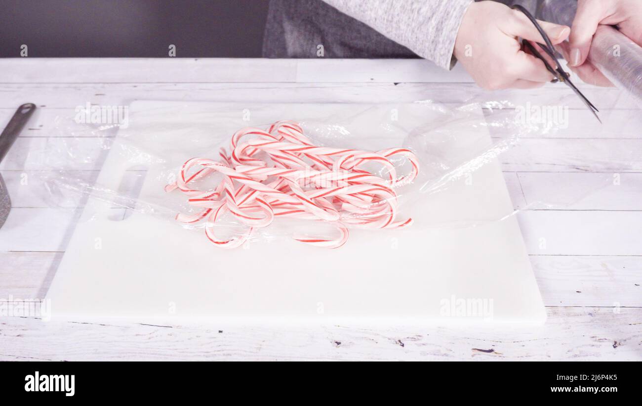 Step by step. Breaking candy cane candies into small pieces Stock Photo ...